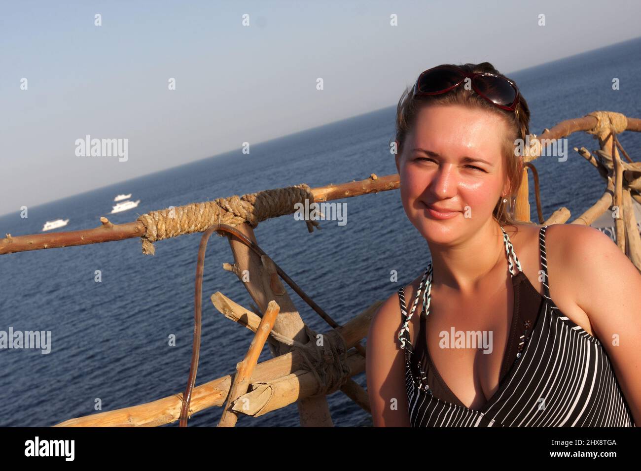 Sunburnt woman poses on Red Sea background, Egypt Stock Photo - Alamy
