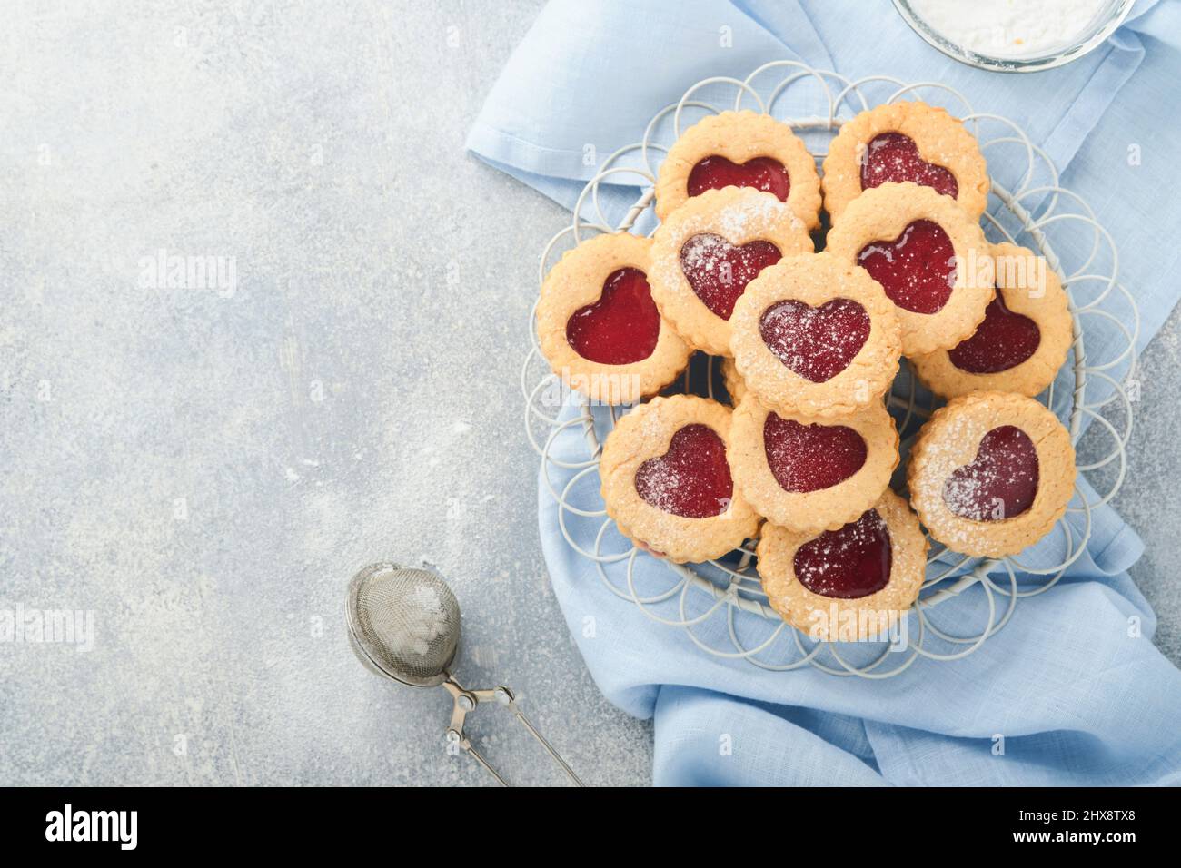 Traditional Linzer cookie with strawberry jam and powder sugar on light ...