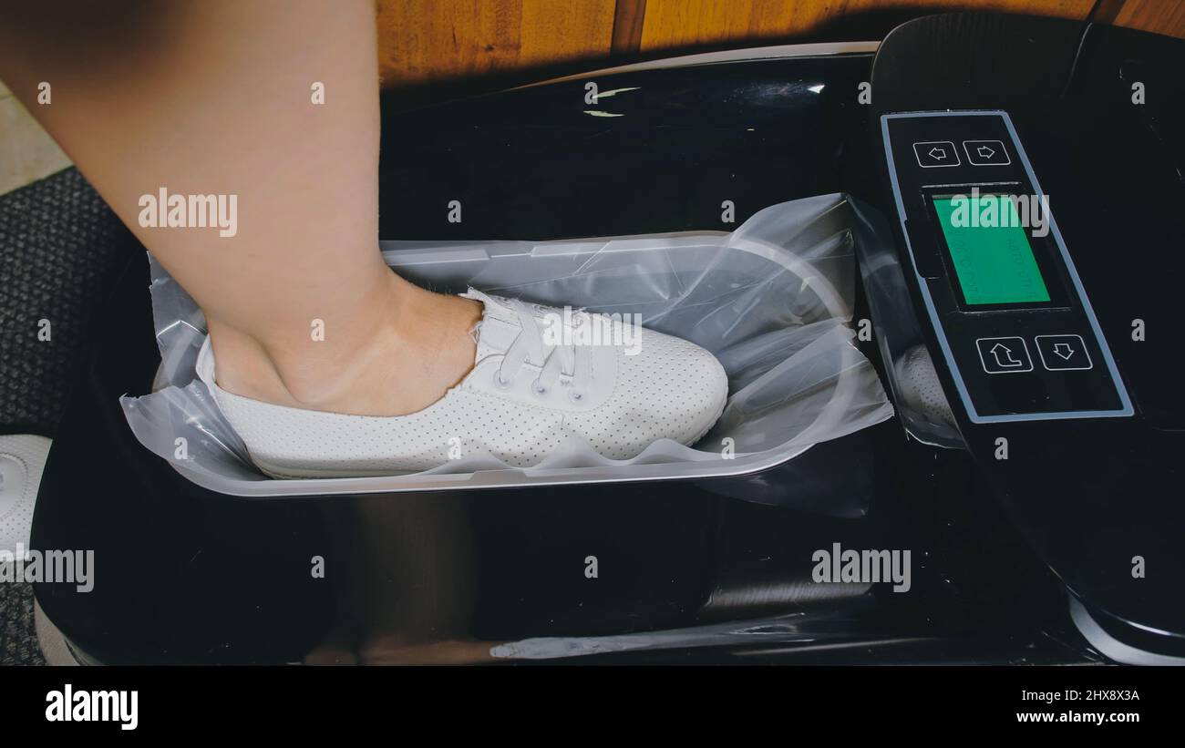 Automatic Thermal Shrinkable Shoe Cover Laminating Machine. Close up ...