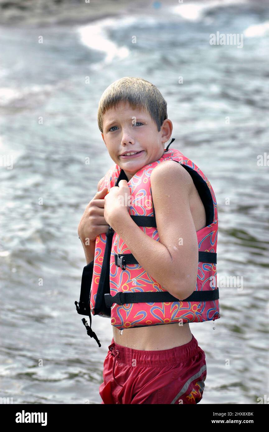 Wet face10 year old Boy in lifejacket PDF in cold of lake in fall Stock ...