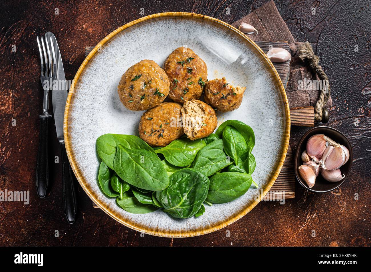 Fish Cakes or Fish balls with tuna and spinach in a plate. Dark ...