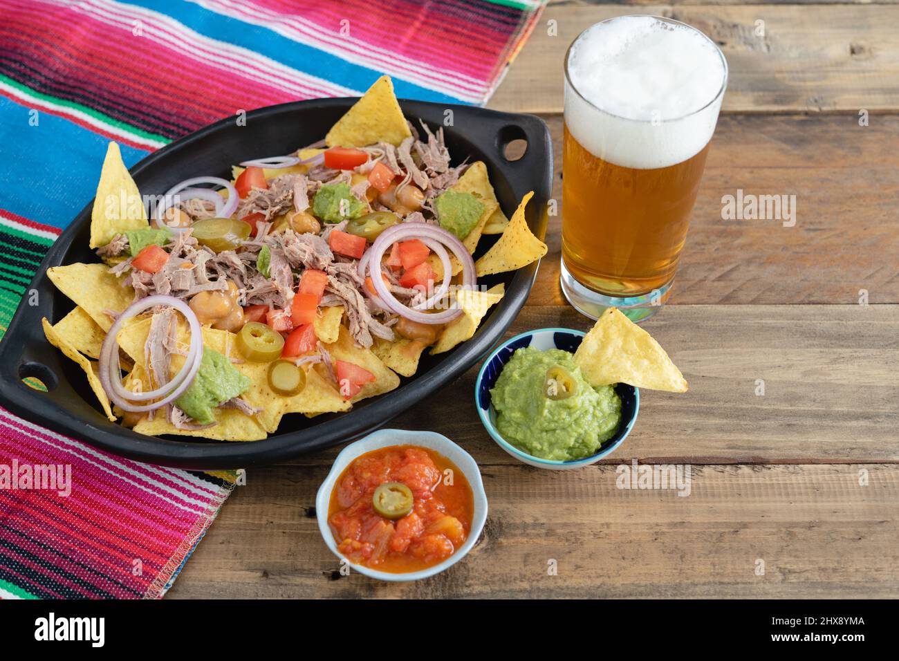 Tray with nachos, sauces and beer Stock Photo - Alamy