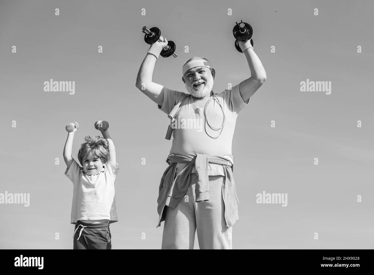 Grandfather and son doing exercises. Father and children having workout ...