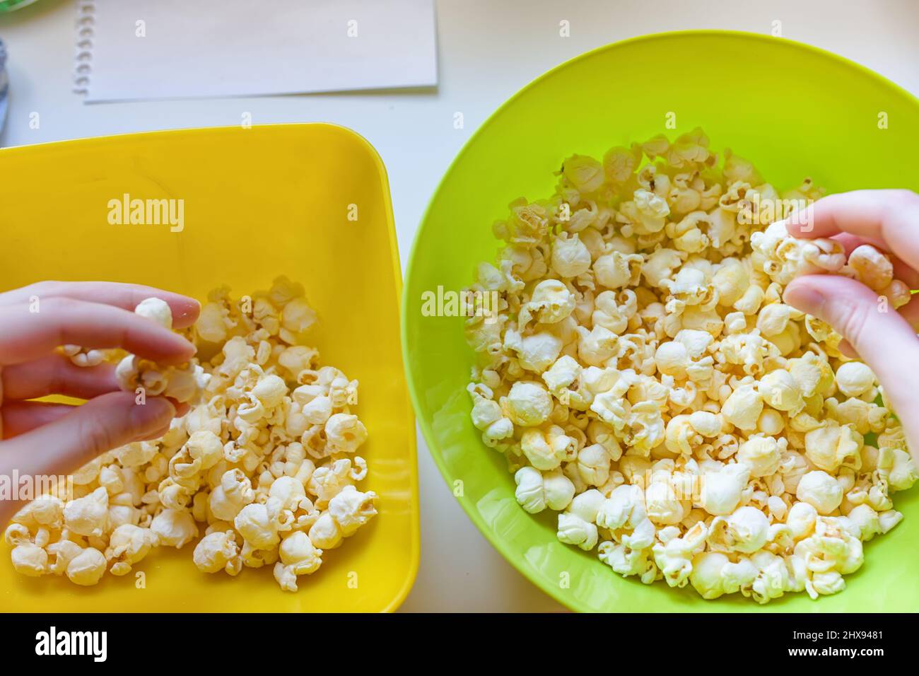 A bucket of popcorn, top-view, warm colors, daylight macro close-up ...