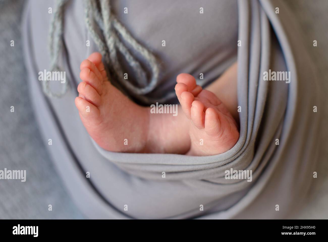 Small beautiful legs of a newborn baby in the first days of life. Baby ...