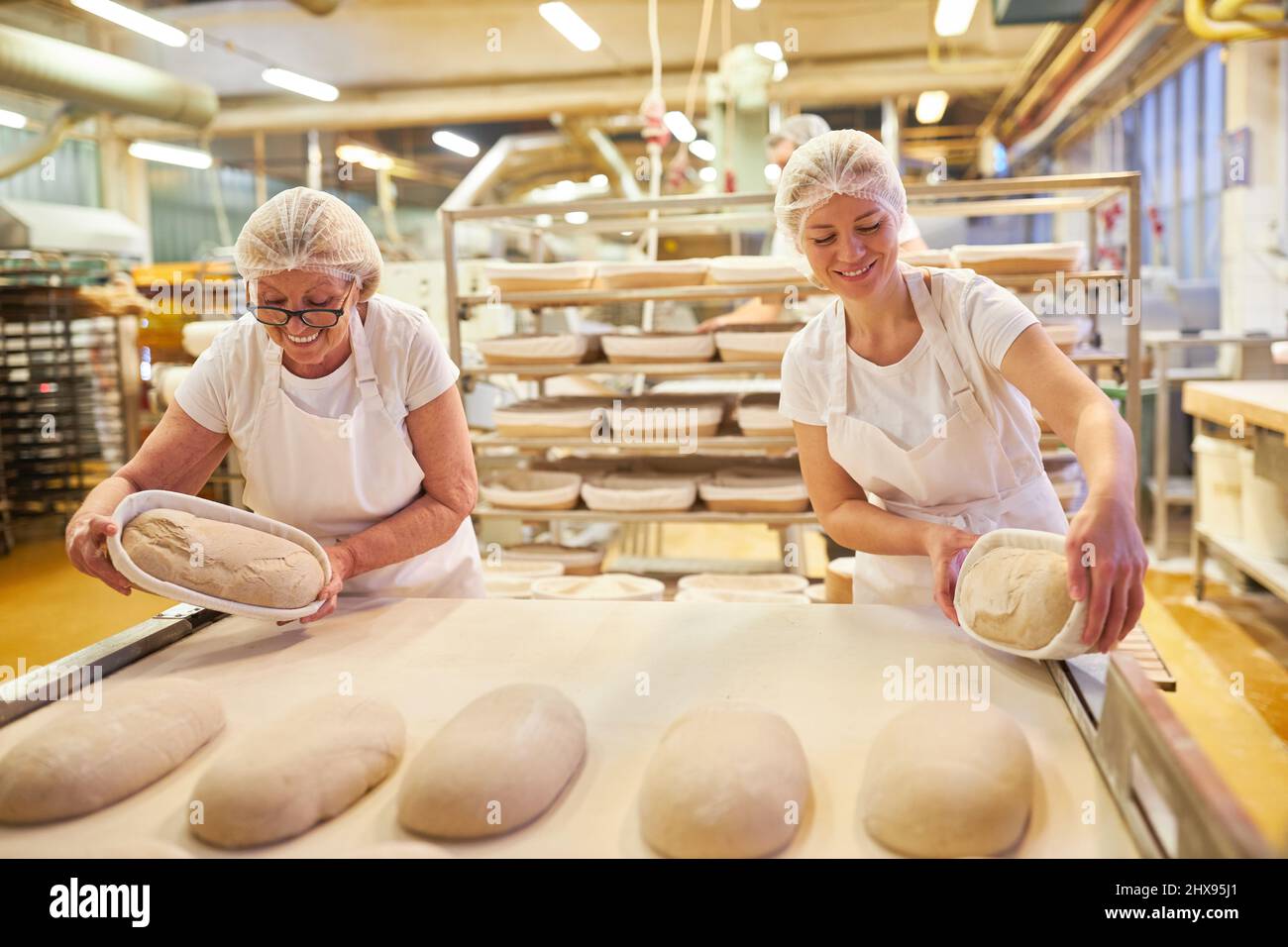 Woman baking bread in a factory hi-res stock photography and images - Alamy