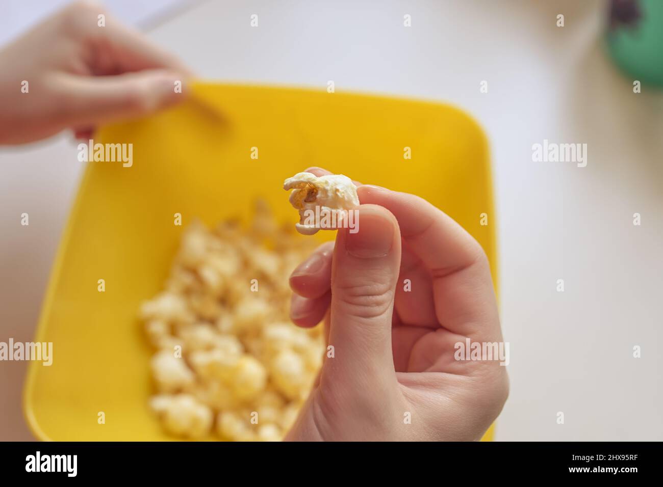 A bucket of popcorn, top-view, warm colors, daylight macro close-up ...