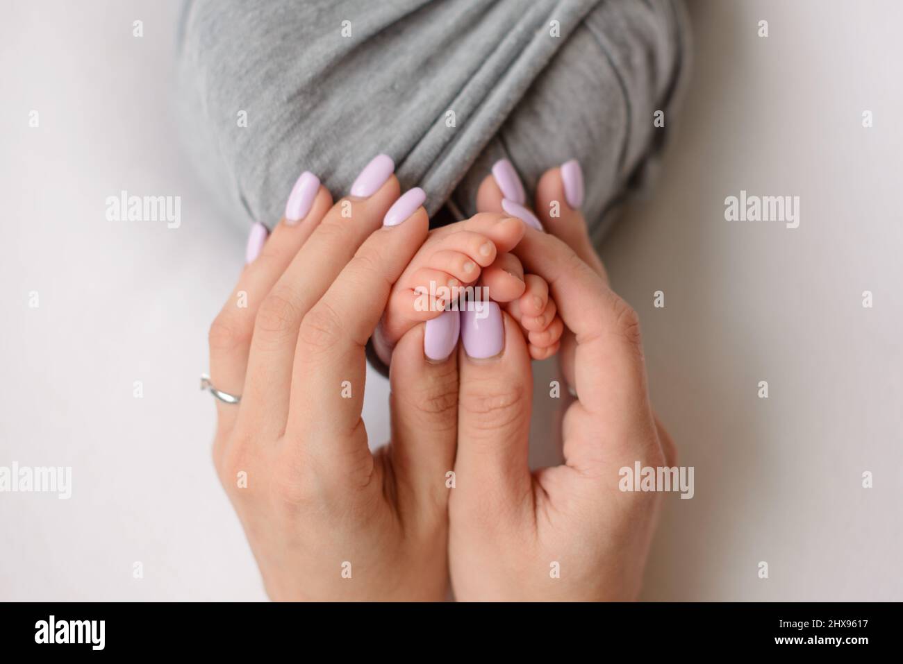Small beautiful legs of a newborn baby in the first days of life. Baby ...