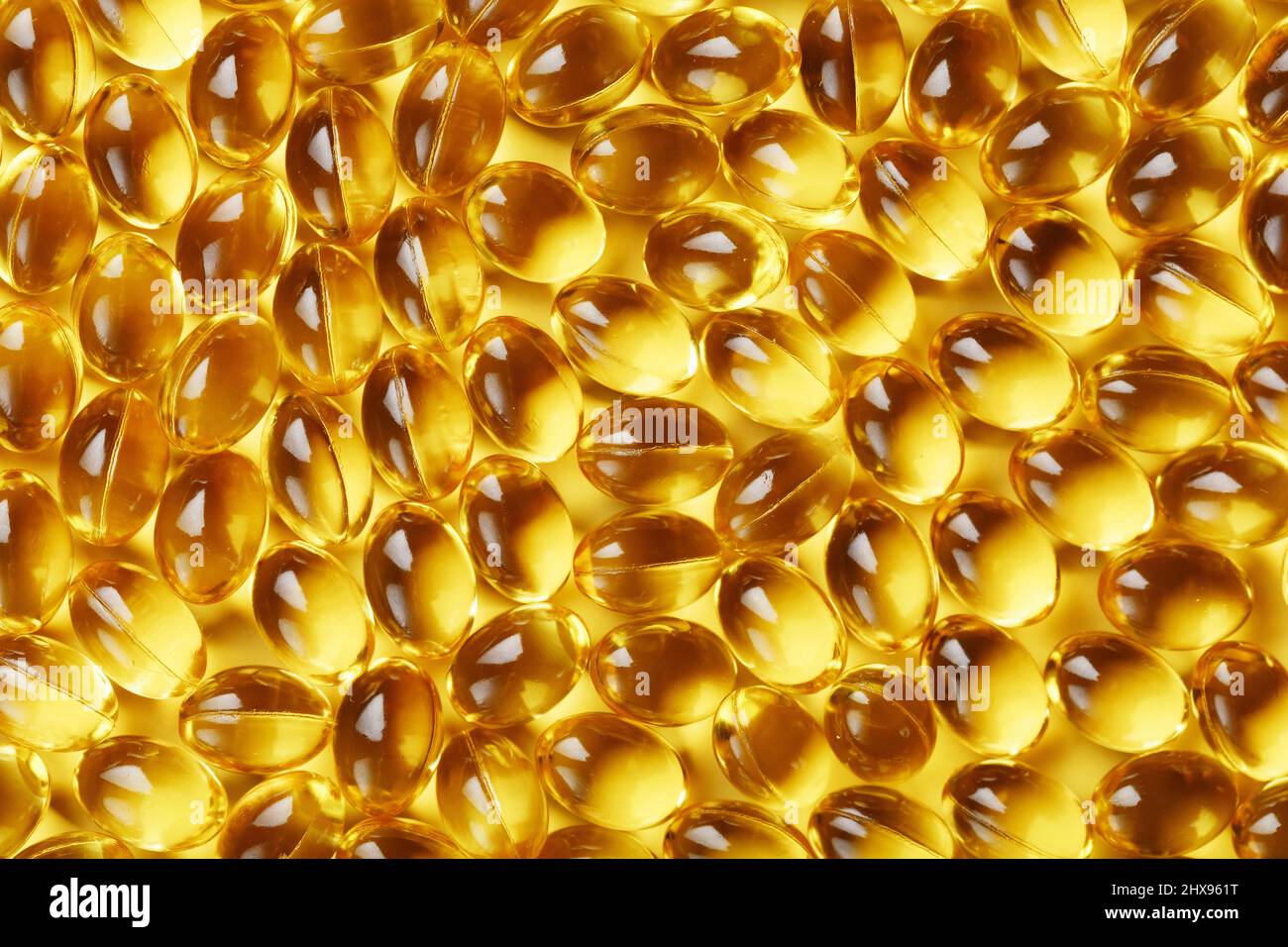 Golden capsules of Vitamin Omega 3 Fish Oil close-up in full screen ...