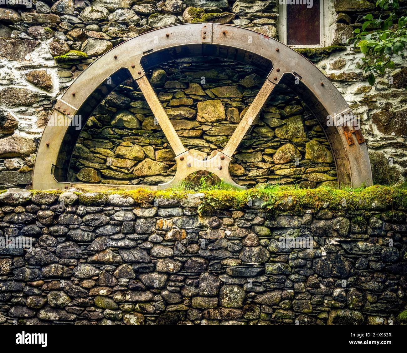 Water wheel with a stone wall in front of it Stock Photo - Alamy
