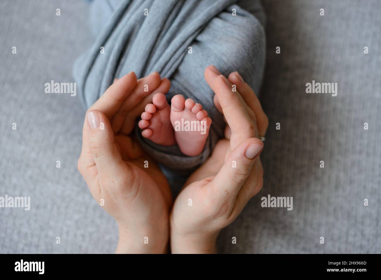 Small beautiful legs of a newborn baby in the first days of life. Baby ...