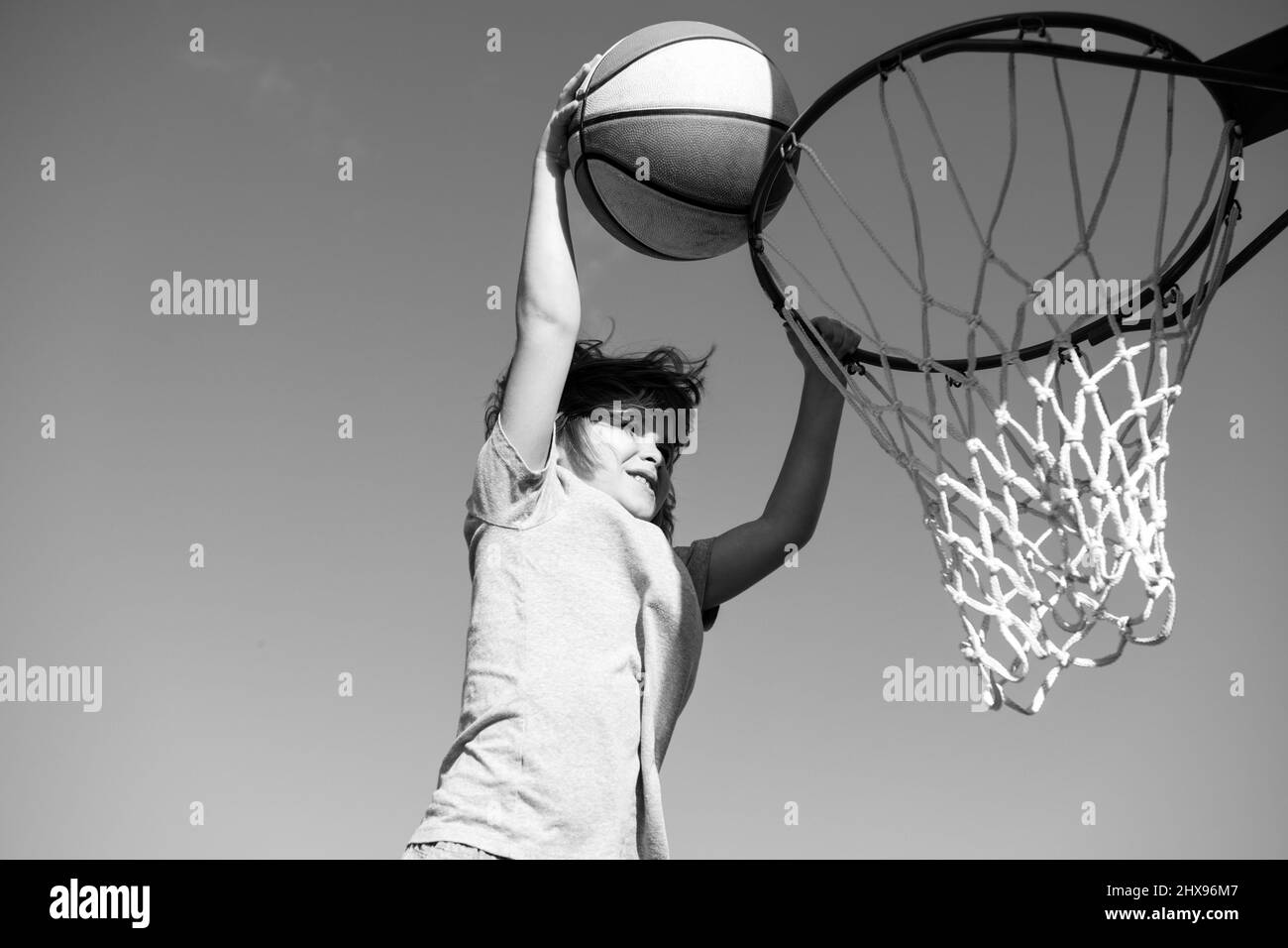 Basketball player making slam dunk Black and White Stock Photos ...