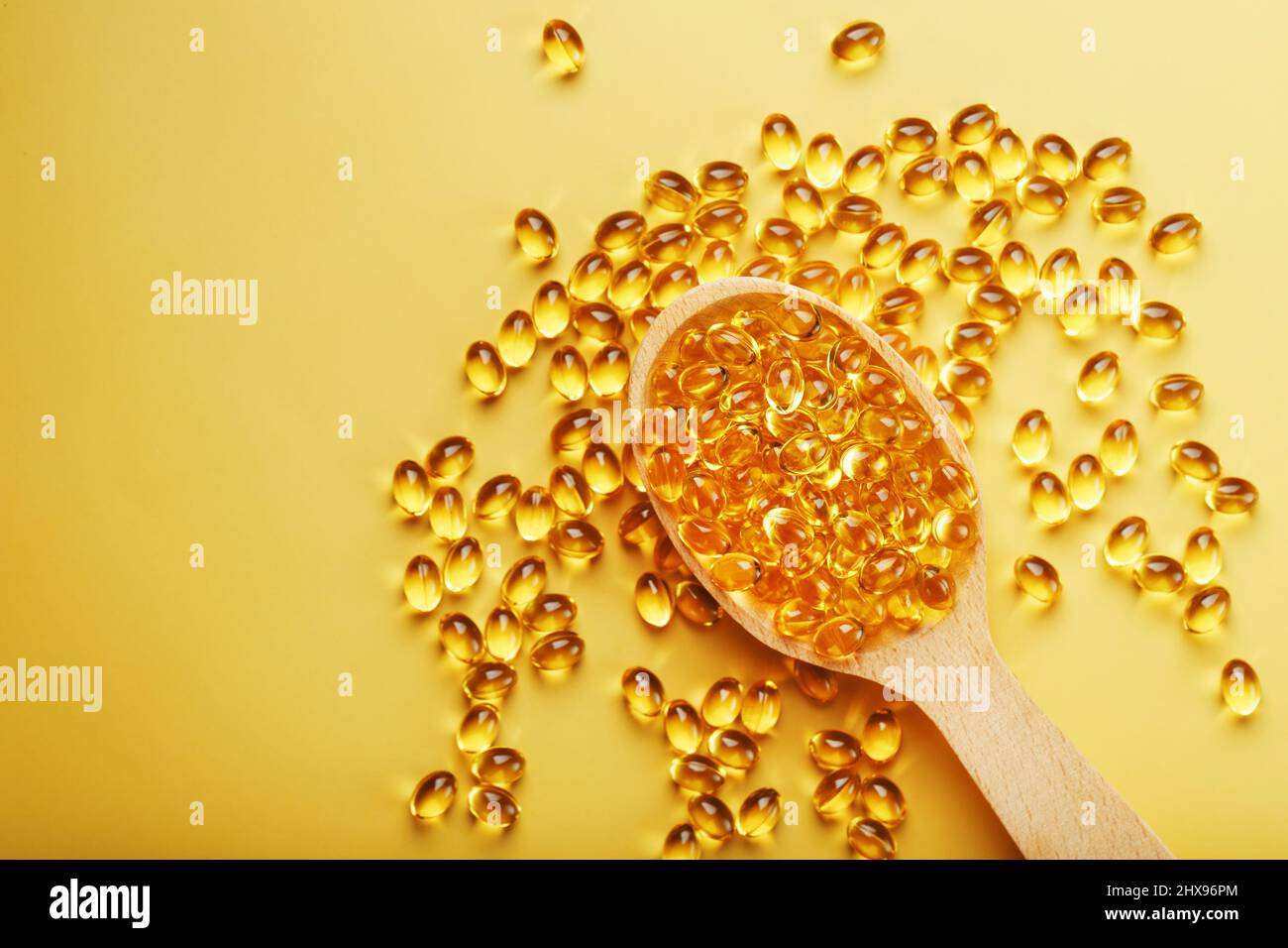 Vitamin D3 Capsules in a spoon with other vitamin D3 capsules around ...