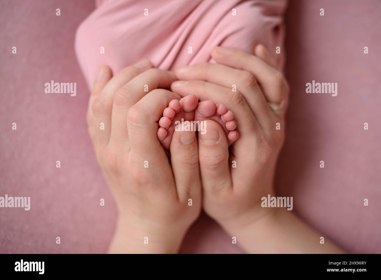 Small beautiful legs of a newborn baby in the first days of life. Baby ...