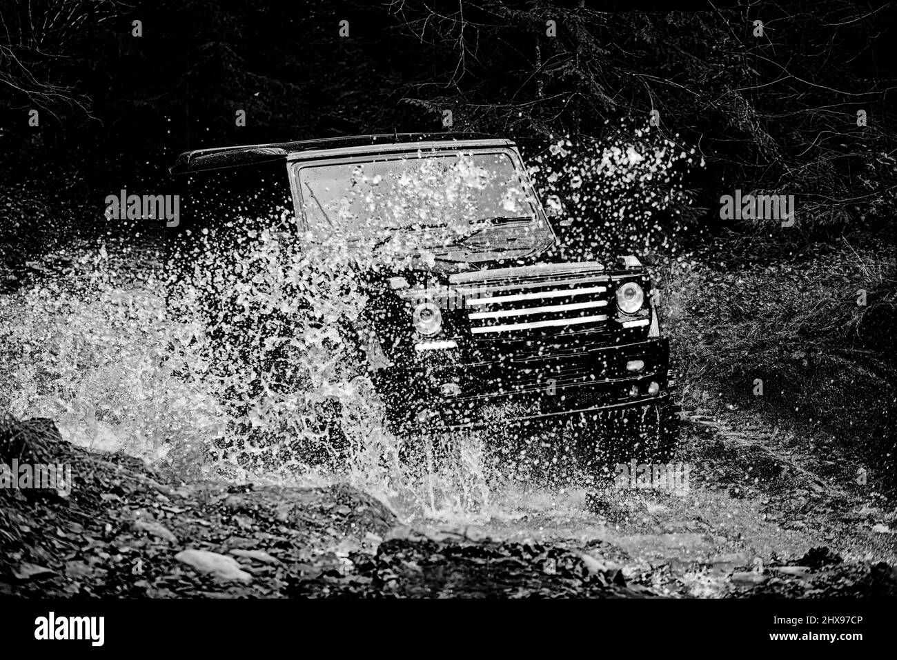 Off-road travel on mountain road. Mud and water splash in off the road ...