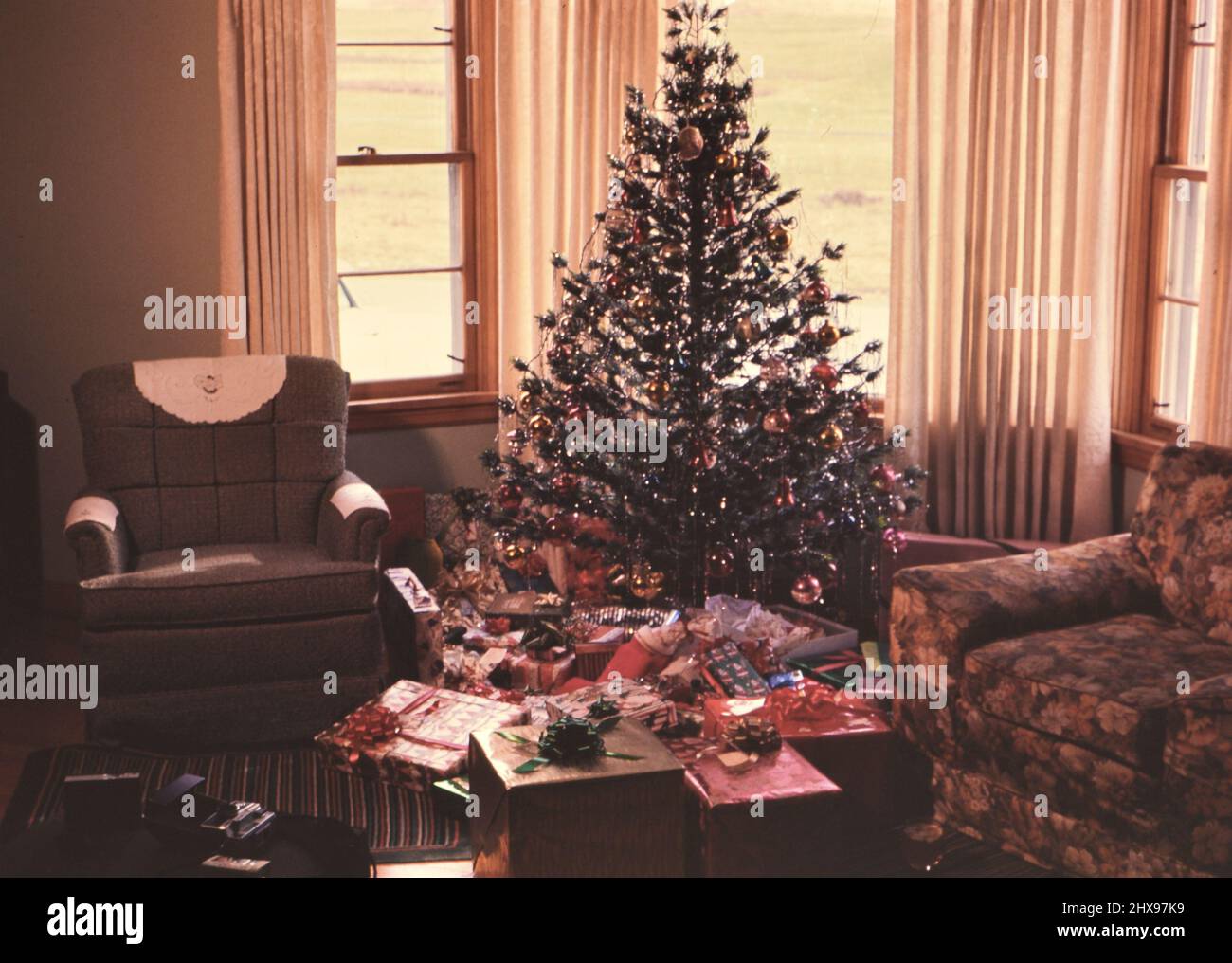 Christmas tree in a living room in front of a window ca. 1968 Stock ...