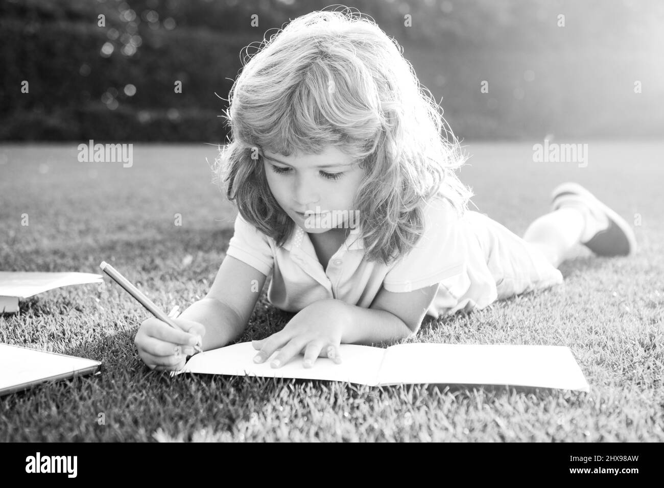Adorable child writing on Black and White Stock Photos & Images - Alamy