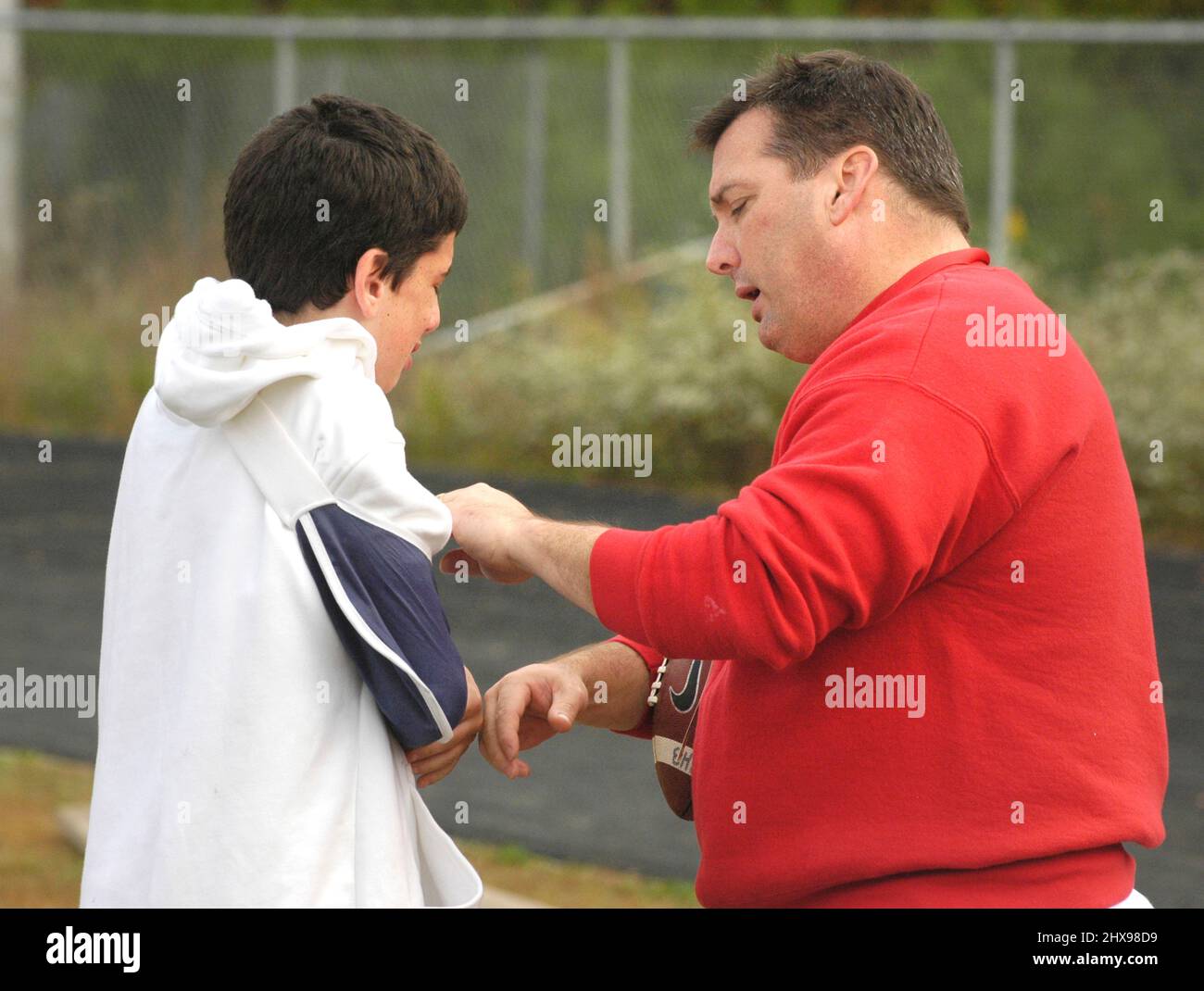 Injured young football player with sad face and arm in cast from ...