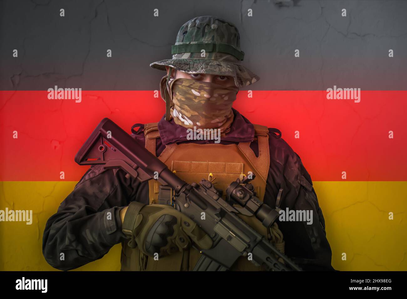 Angry germany soldier armed with rifle with german flag as background ...