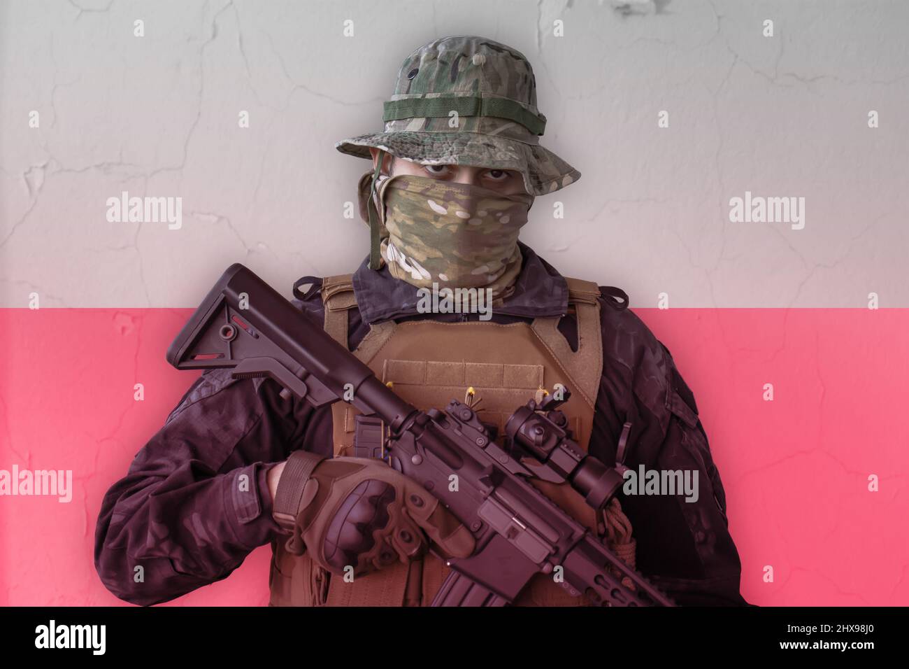 Angry polish soldier armed with rifle with poland flag as background ...