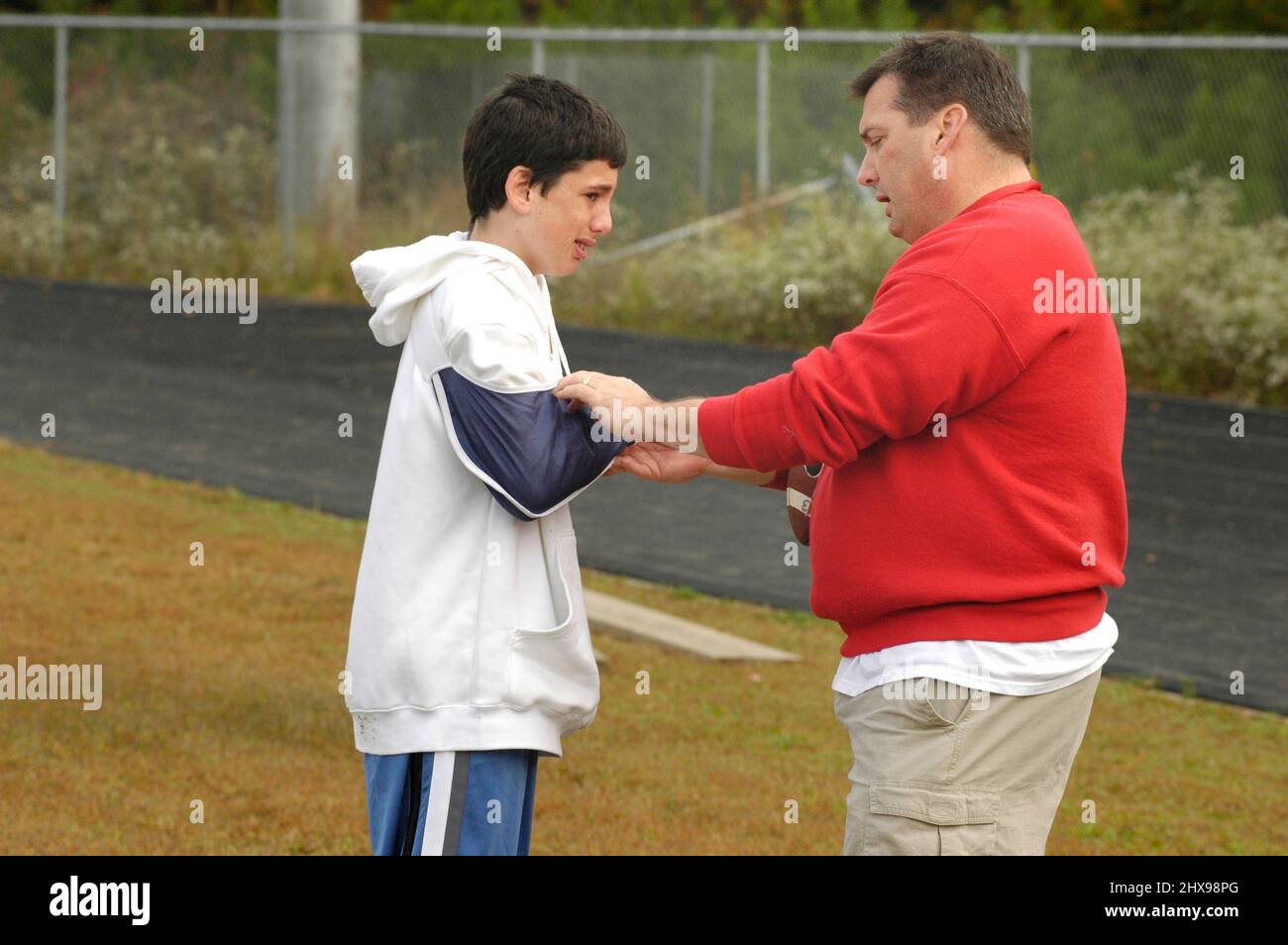 Injured young football player with sad face and arm in cast from ...