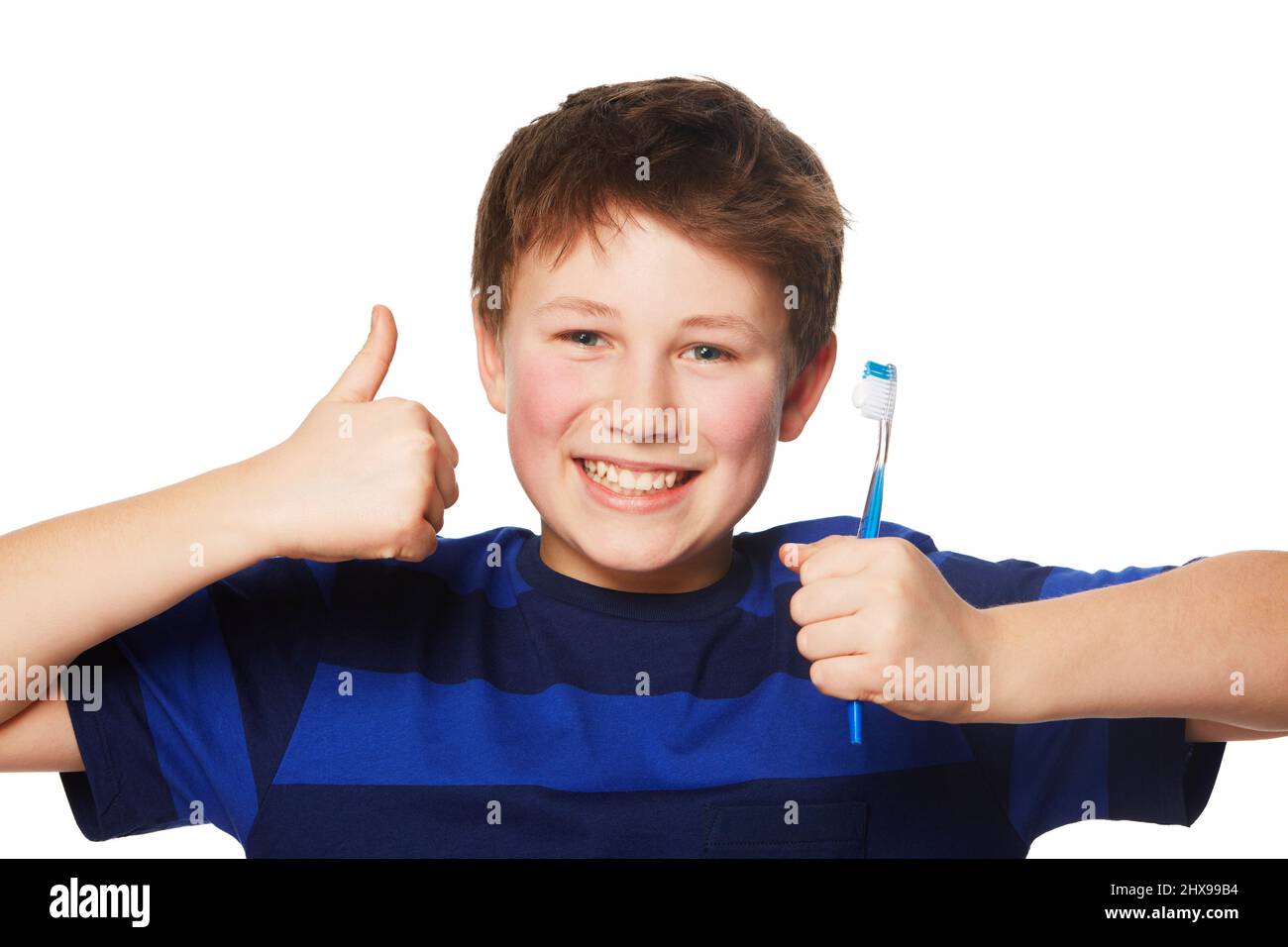 Dental hygiene gets the thumbs up. Portrait of a young boy holding is ...