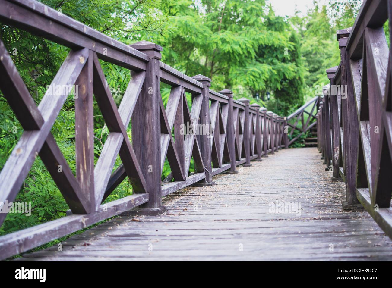 Wooden bridge with wooden railing Stock Photo - Alamy