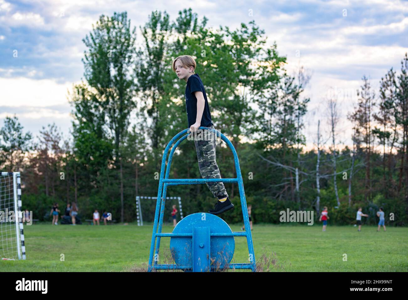 Boy on a street playground on a treadmill Stock Photo - Alamy