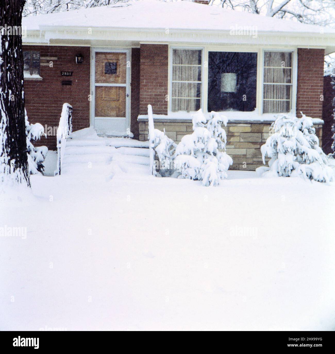 Front of a middle class home after a heavy snowfall ca. 1971 Stock ...