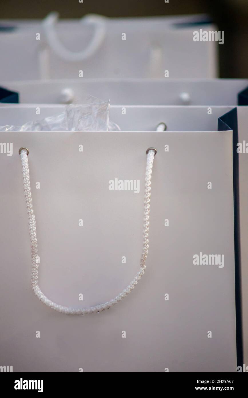 White paper bags with rope handles Stock Photo - Alamy