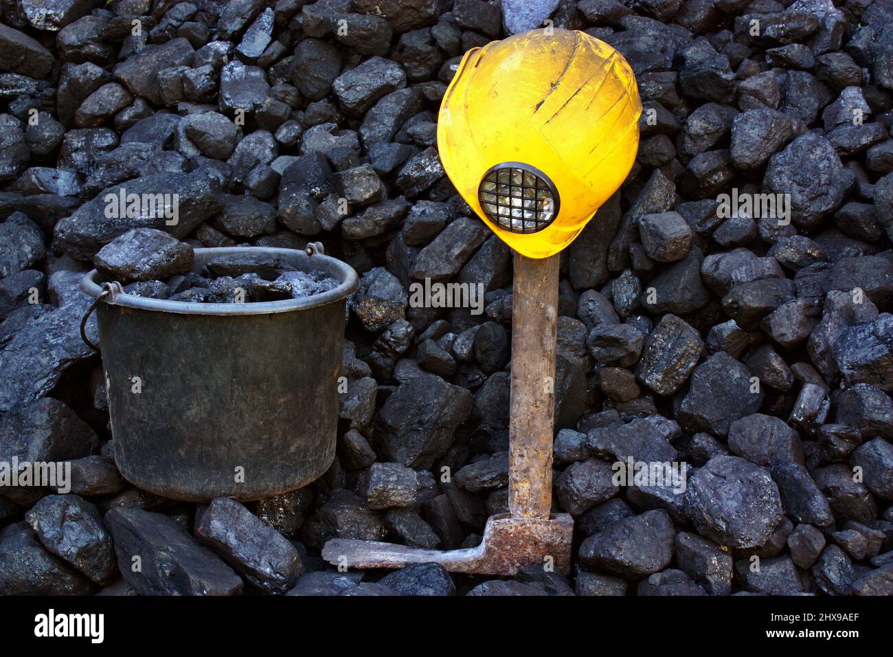 Polish coal of mine deposit showing with miners equipment, helmet ...