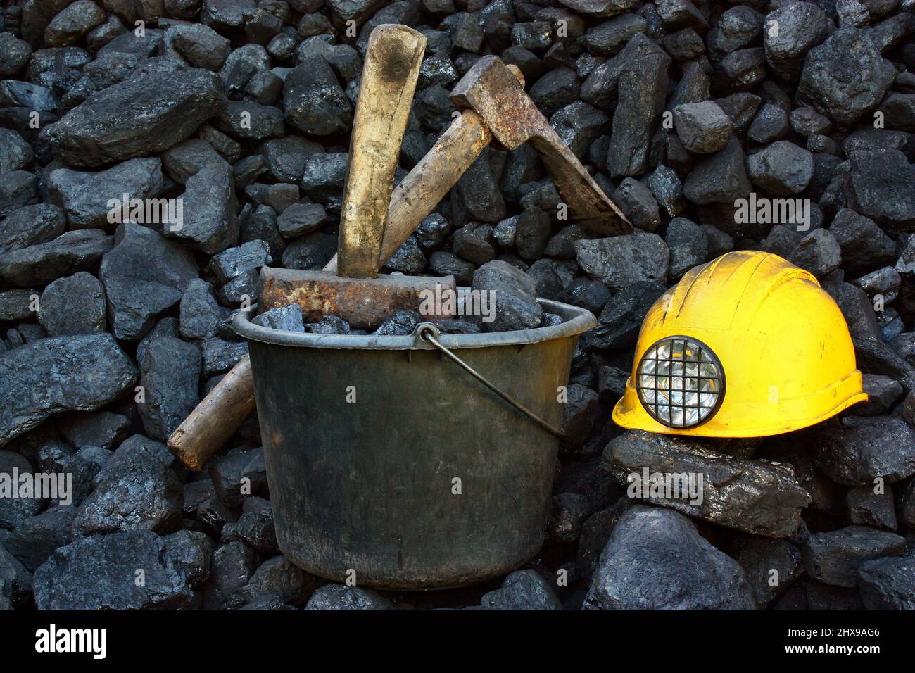 Polish coal of mine deposit showing with miners equipment, helmet ...