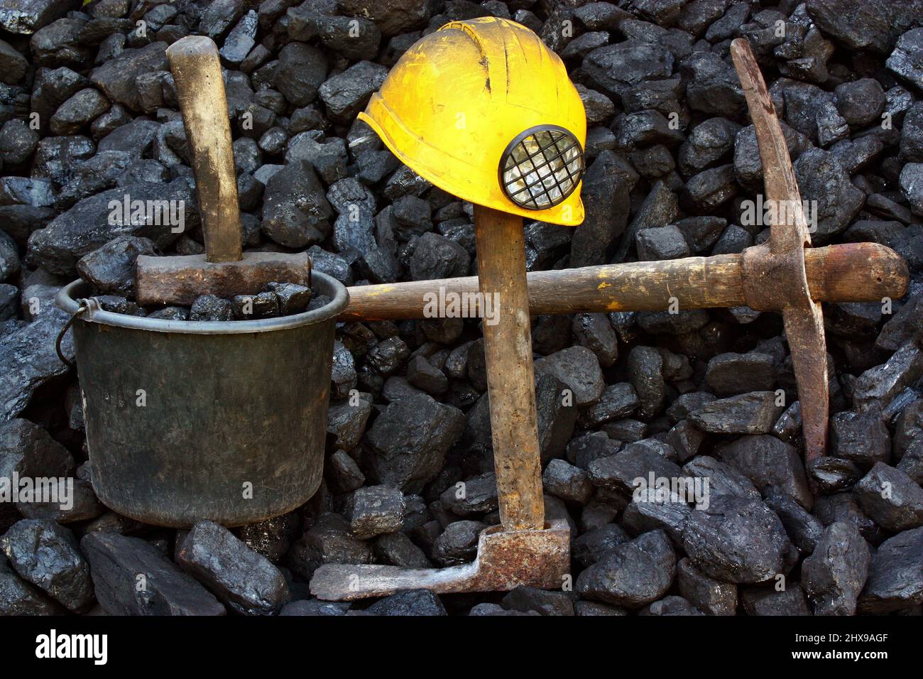Polish coal of mine deposit showing with miners equipment, helmet ...