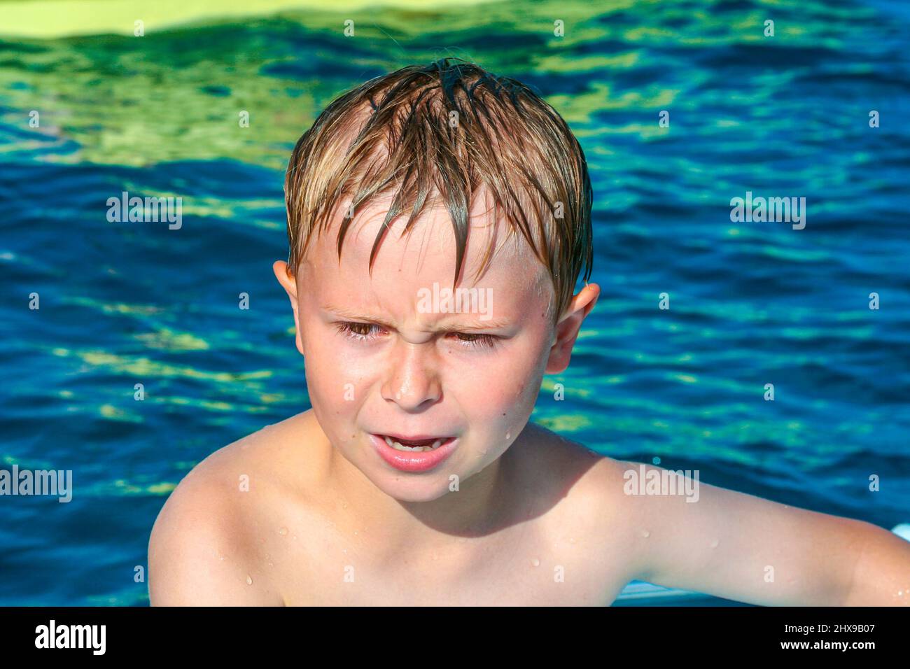 cute boy on a boat is angry and makes a grimace Stock Photo - Alamy