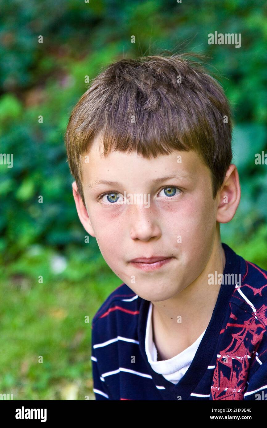 portrait of a friendly seriously looking young boy Stock Photo - Alamy