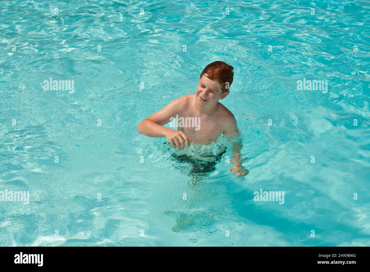 boy has fun swimming in the pool Stock Photo - Alamy