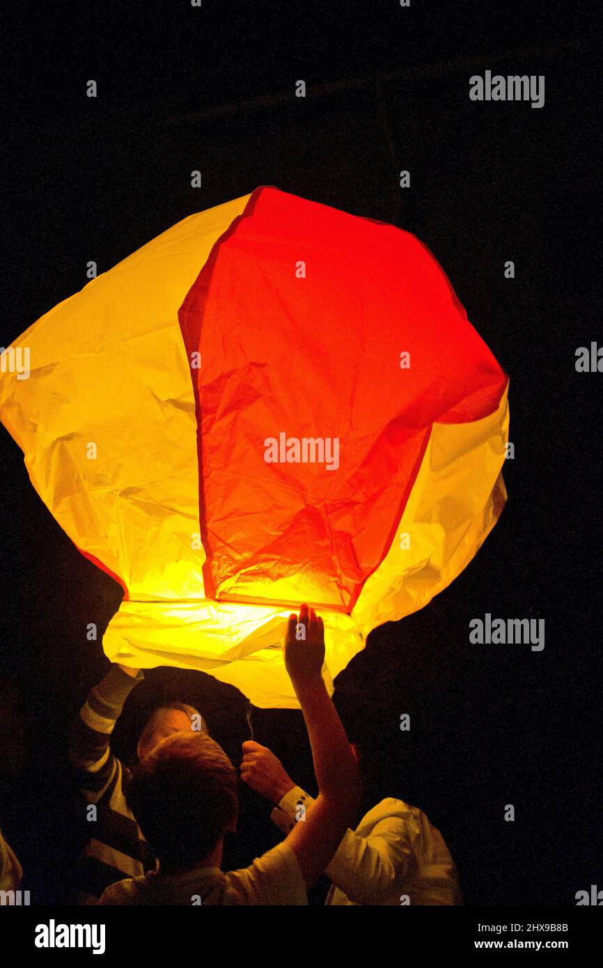 hot air balloon hovering in the air by night Stock Photo - Alamy