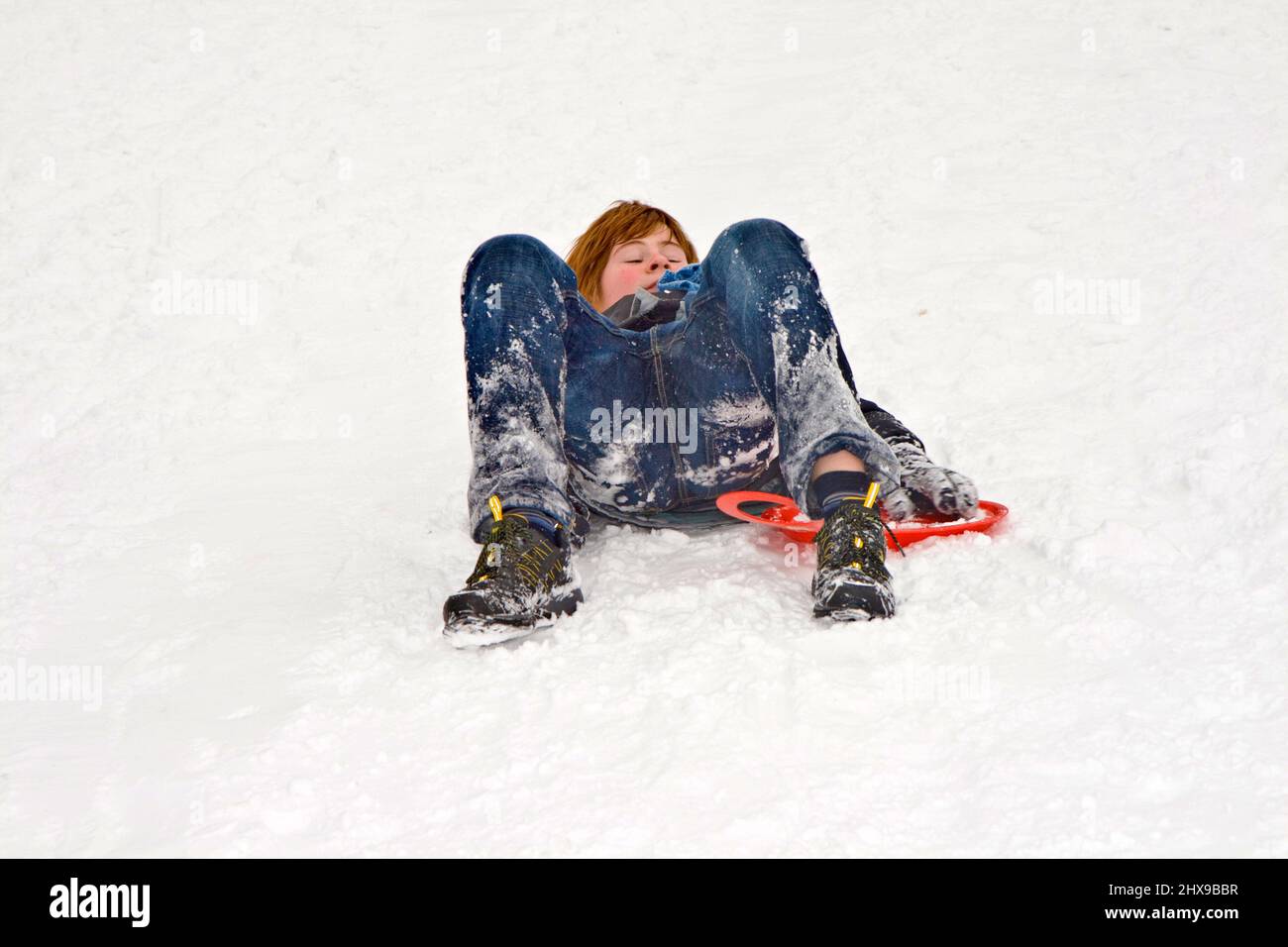 Teen boy sledding down hi-res stock photography and images - Alamy