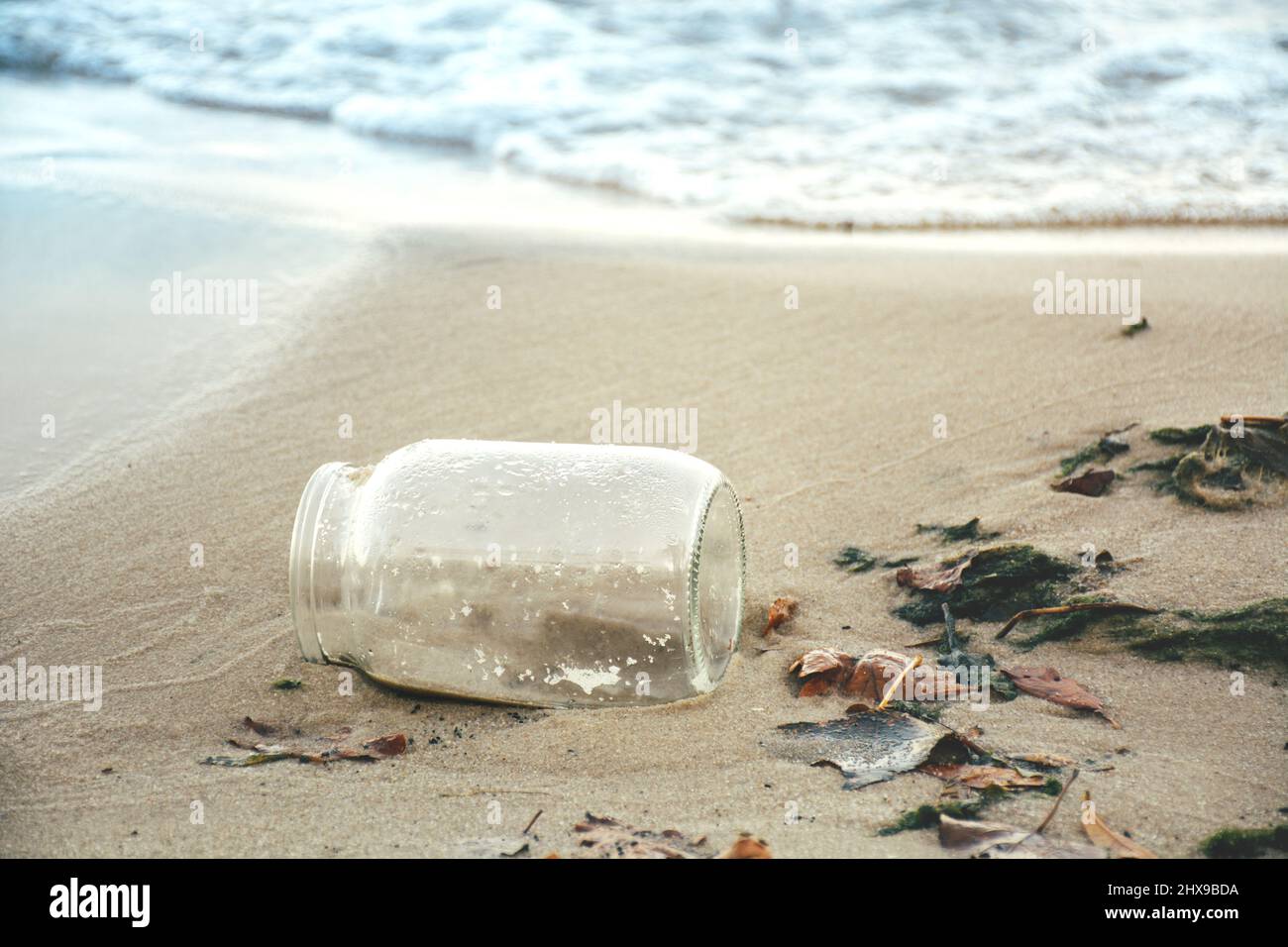 Garbage, waste on the seafront. Glass jar. The concept of cleaning the ...