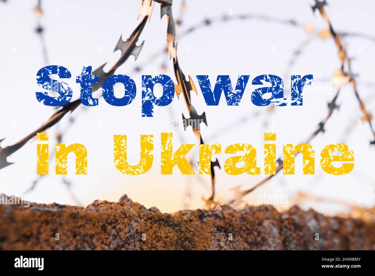 Stop the war in Ukraine. Inscription on a background of barbed wire and ...