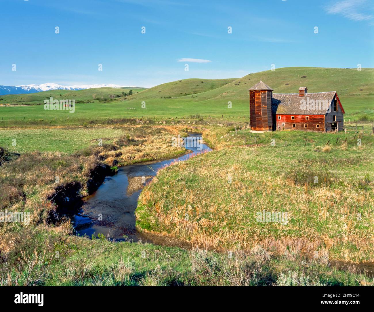 old barn and silo below the beartooth mountains near boyd, montana ...