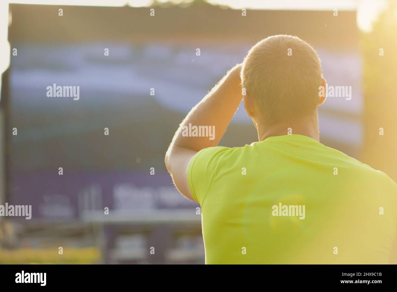 Summer cinema. A man watching a movie in the open air Stock Photo - Alamy