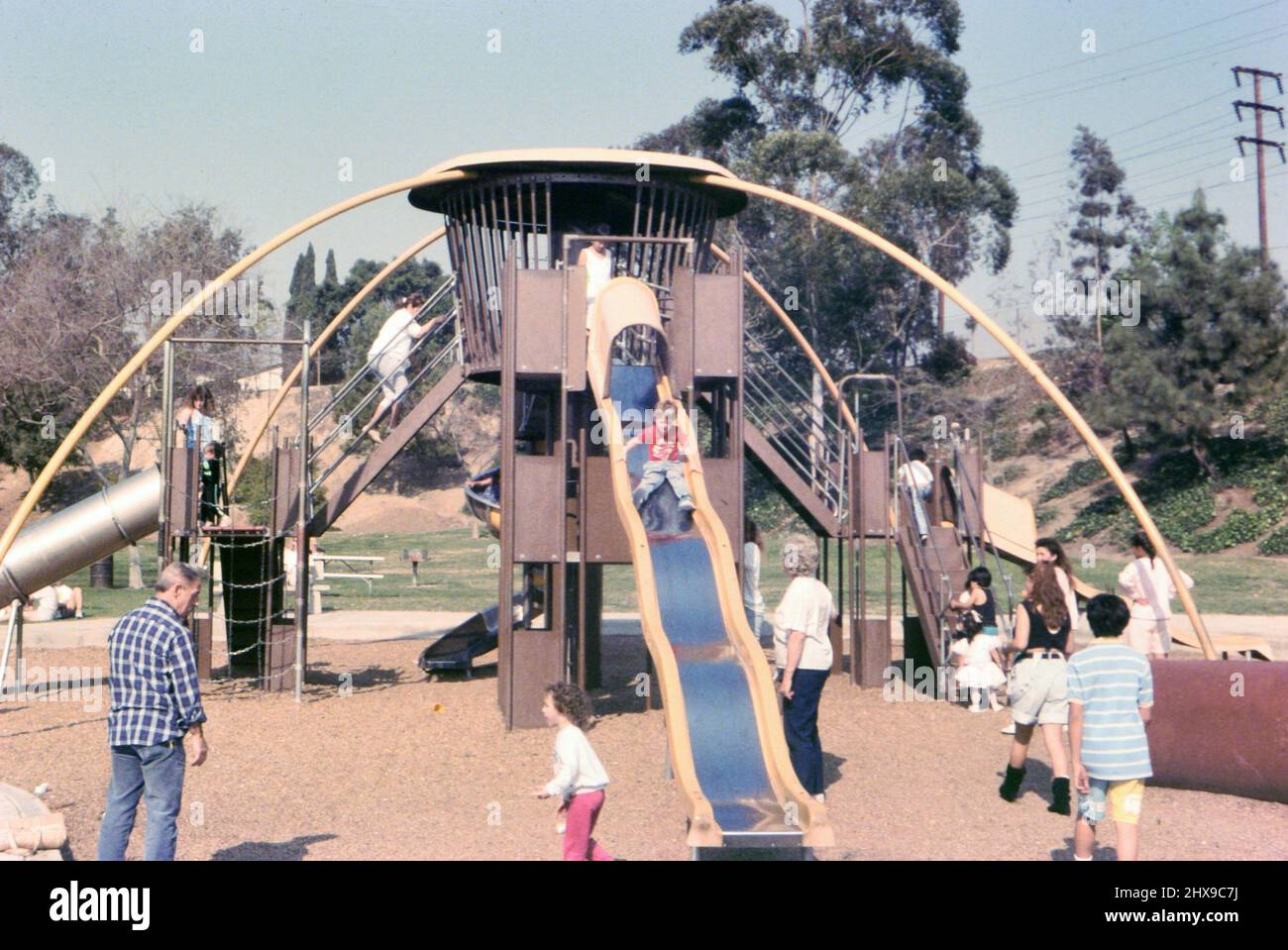 Kids having fun on a playground, playing on a jungle gym and slide ca ...
