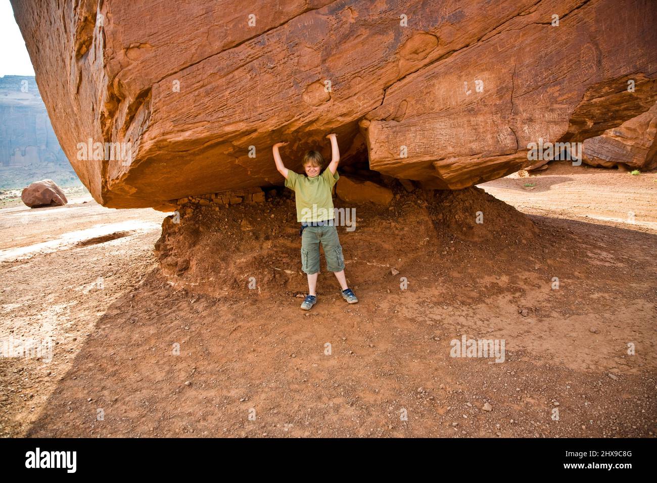 Boy leaning on rock formation hi-res stock photography and images - Alamy