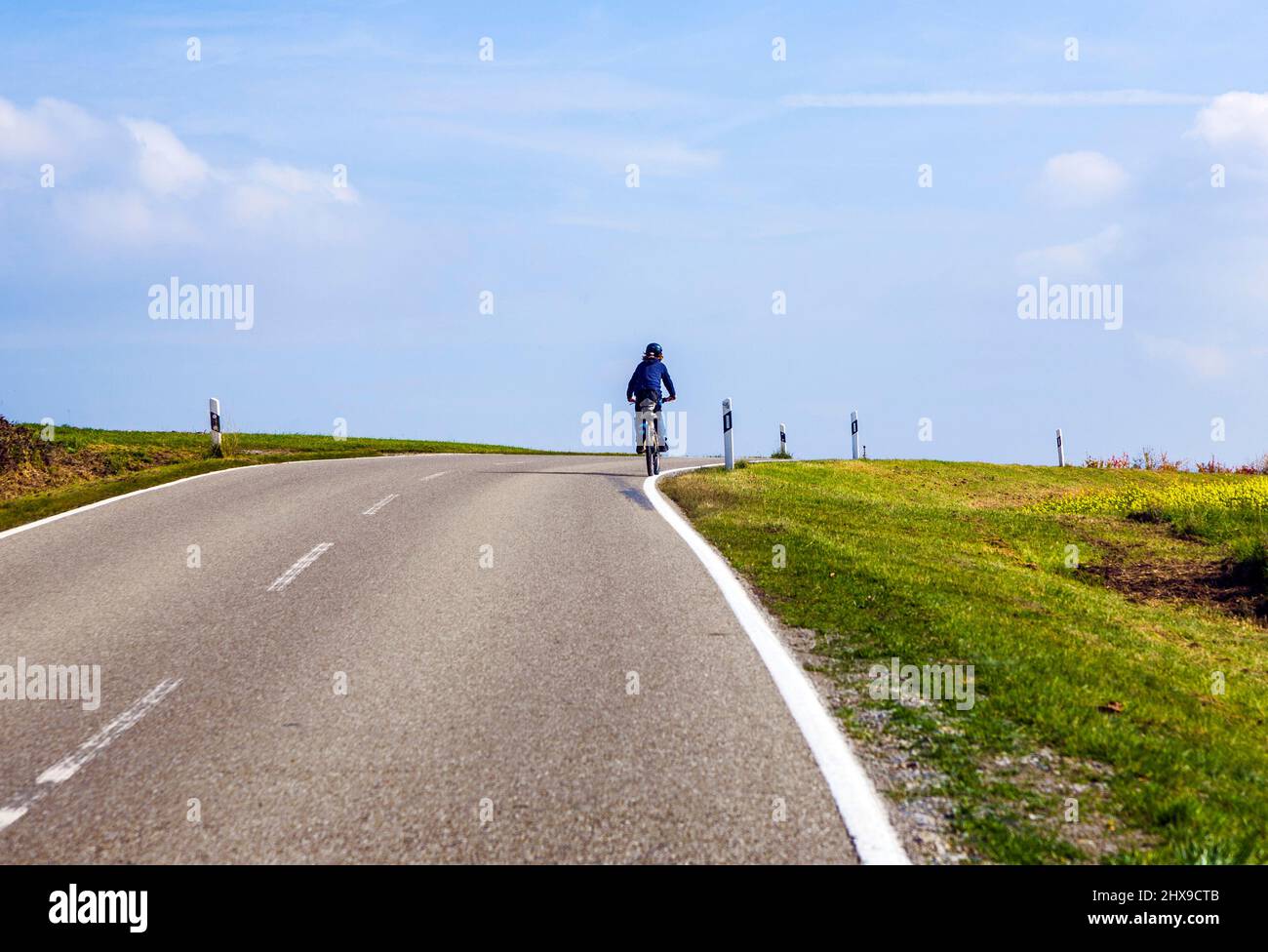 young boy on tour with the bike in rural area Stock Photo - Alamy