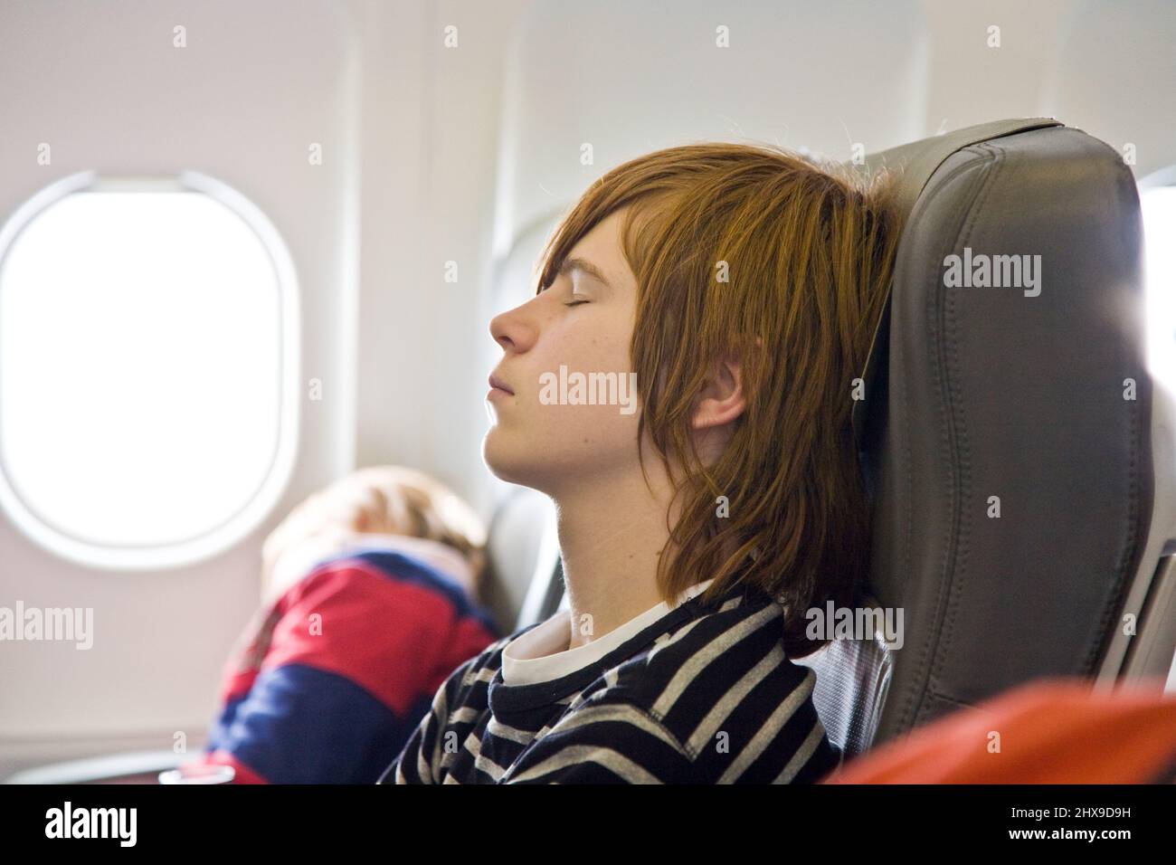 boy sleeping in the aircraft Stock Photo - Alamy