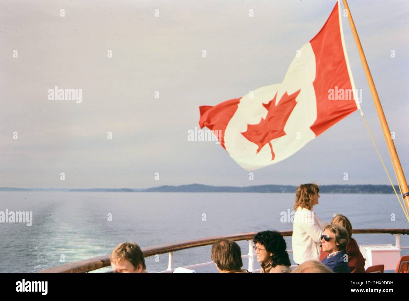 Tourists on a Canadian ship, a Canadian flag flying in the wind ca ...
