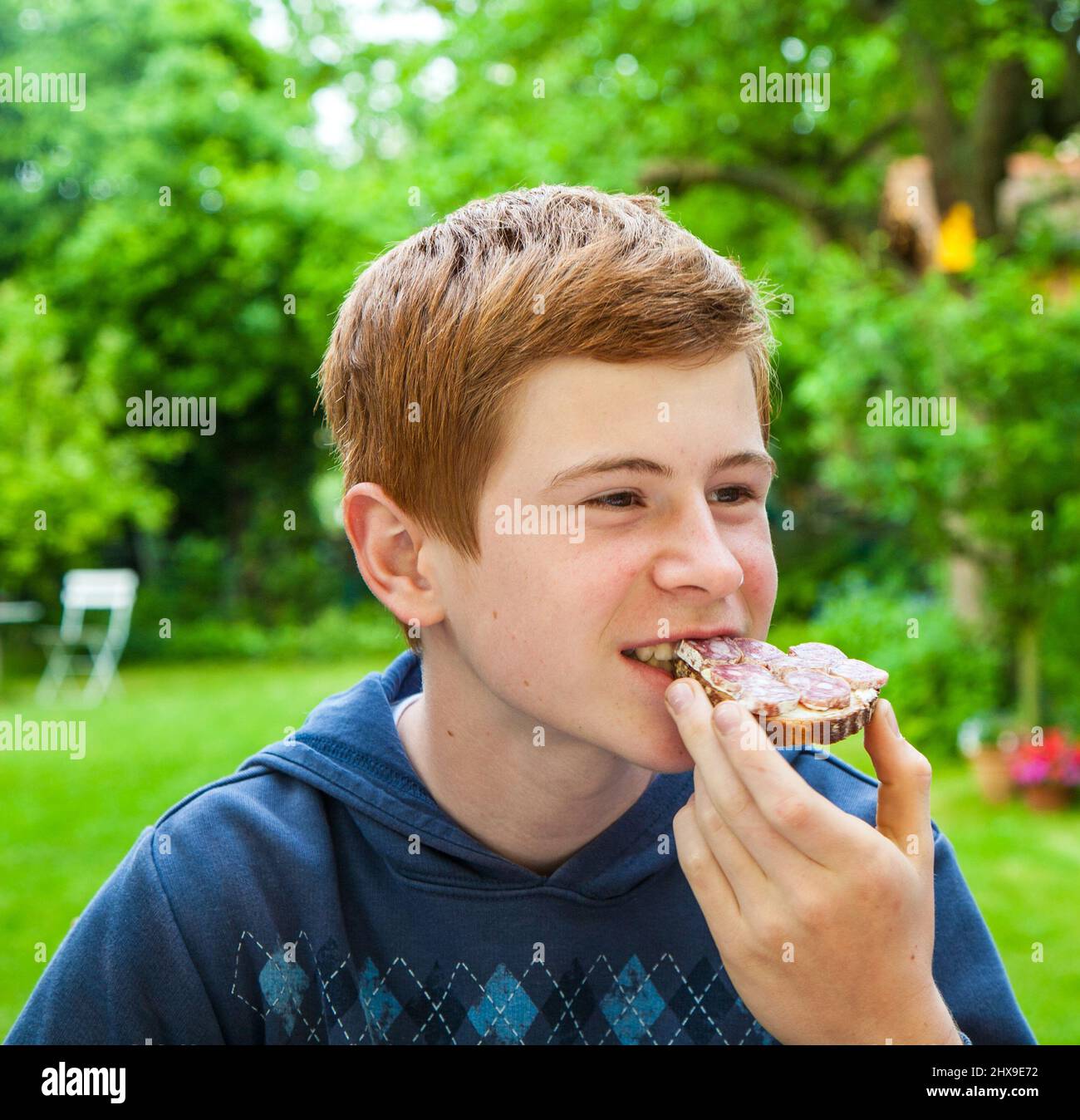boy eating in the garden Stock Photo - Alamy
