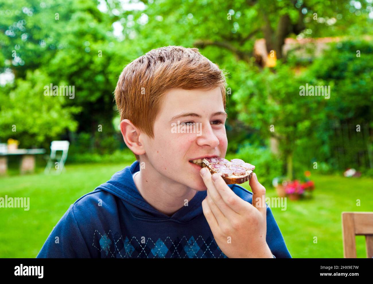 boy eating in the garden Stock Photo - Alamy