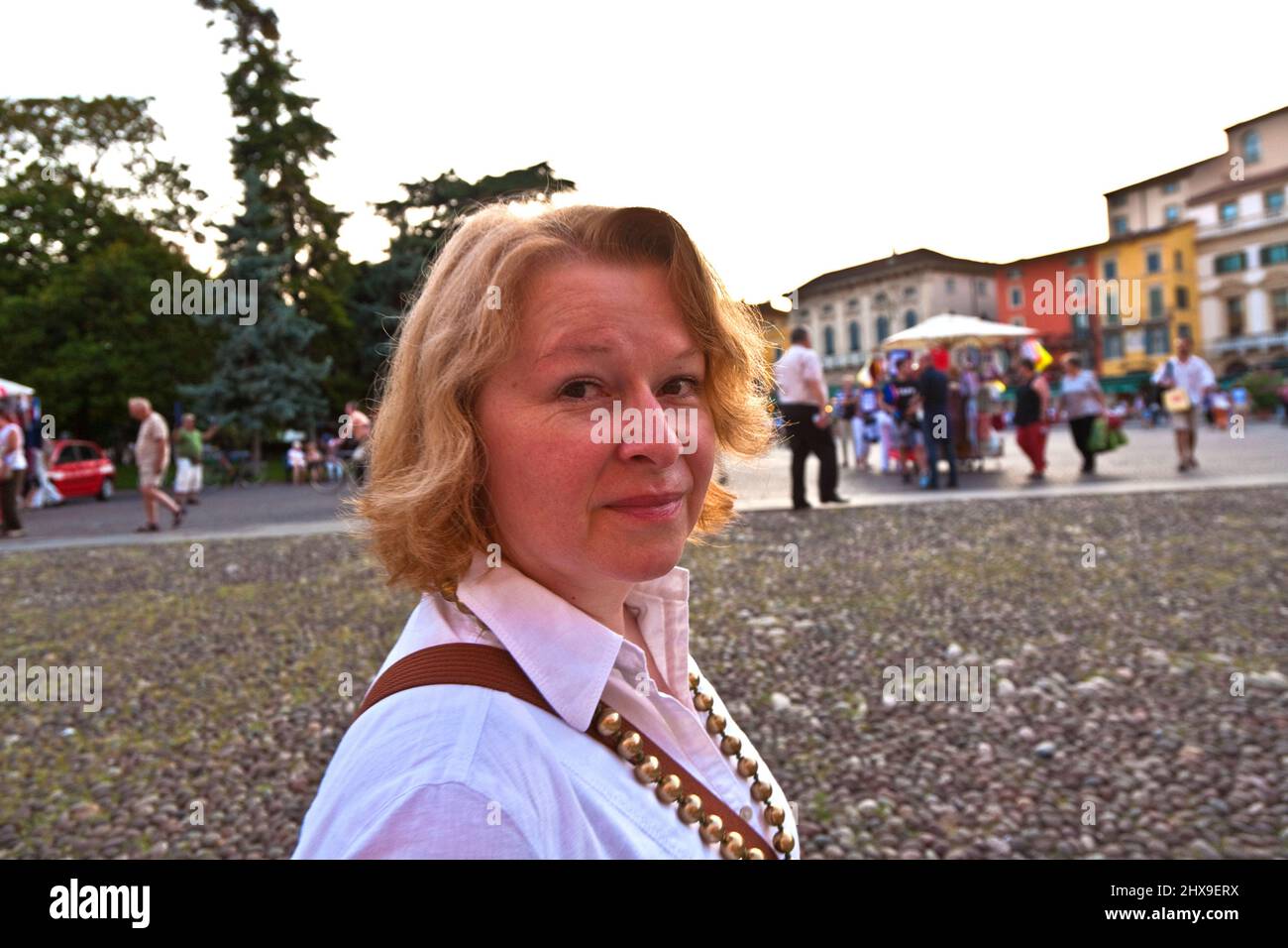 beautiful lady with red hair is waiting for entrance in the arena di ...